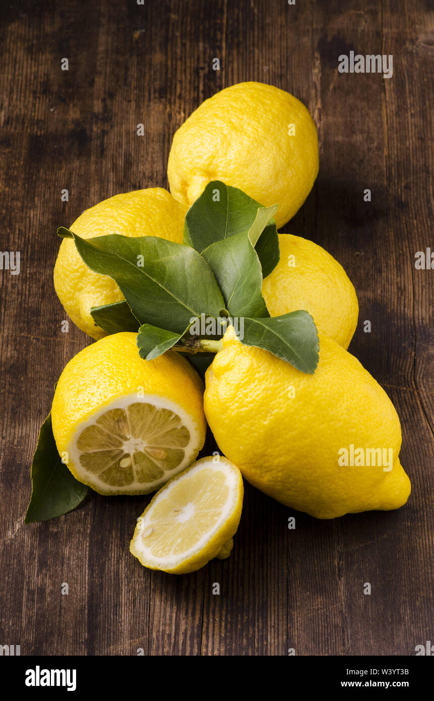 still life with group of lemons with leaf on wooden background Stock ...