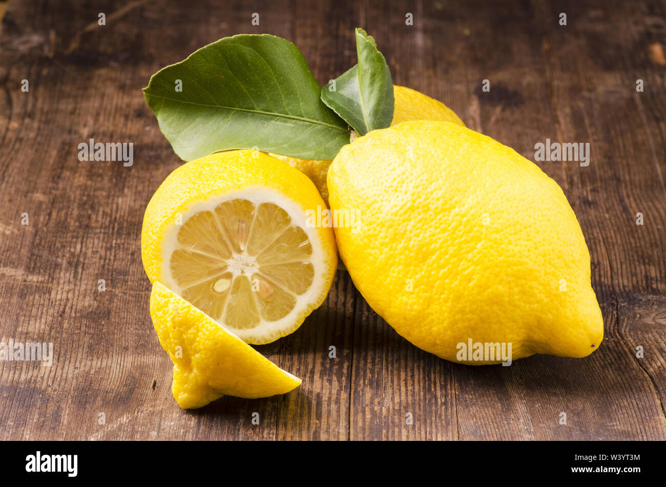still life with group of lemons with leaf on wooden background Stock ...