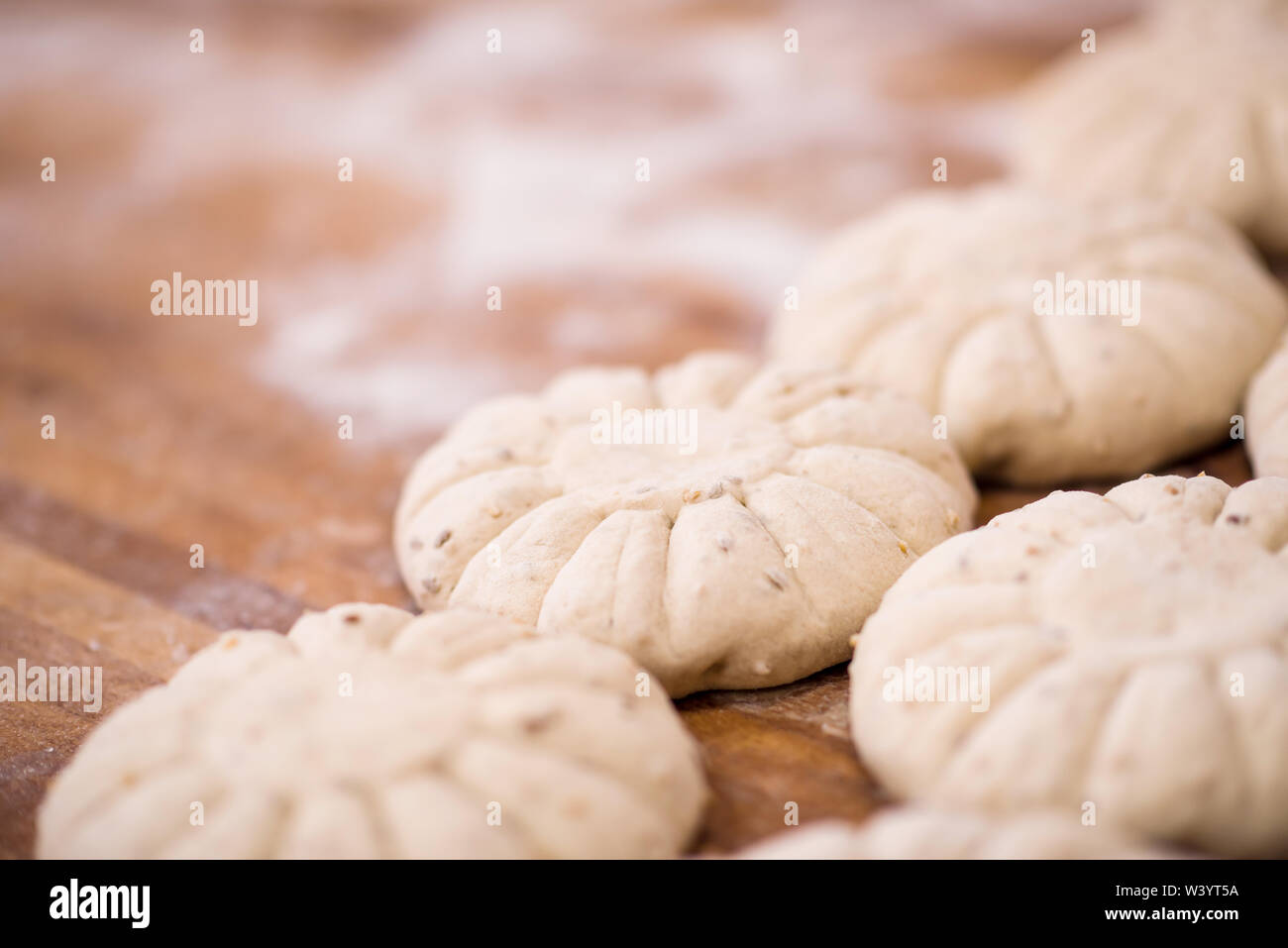 balls of dough bread getting ready to be baked at professional bakery ...
