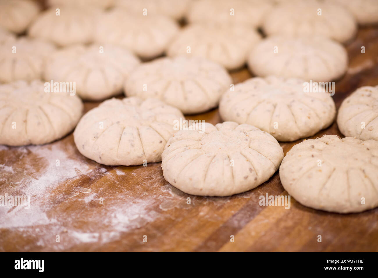 balls of dough bread getting ready to be baked at professional bakery ...
