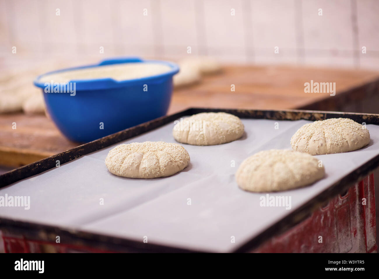 balls of dough bread getting ready to be baked at professional bakery ...