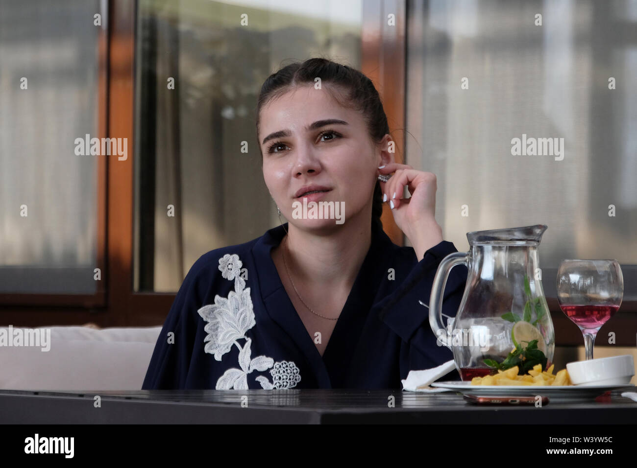A young woman in a cafe in the center of Magas the capital town of the ...
