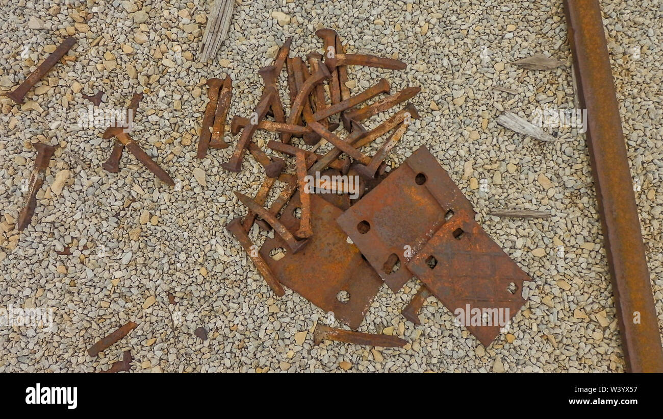 Old rusty railroad iron spikes and plates for train tracks discarded ...