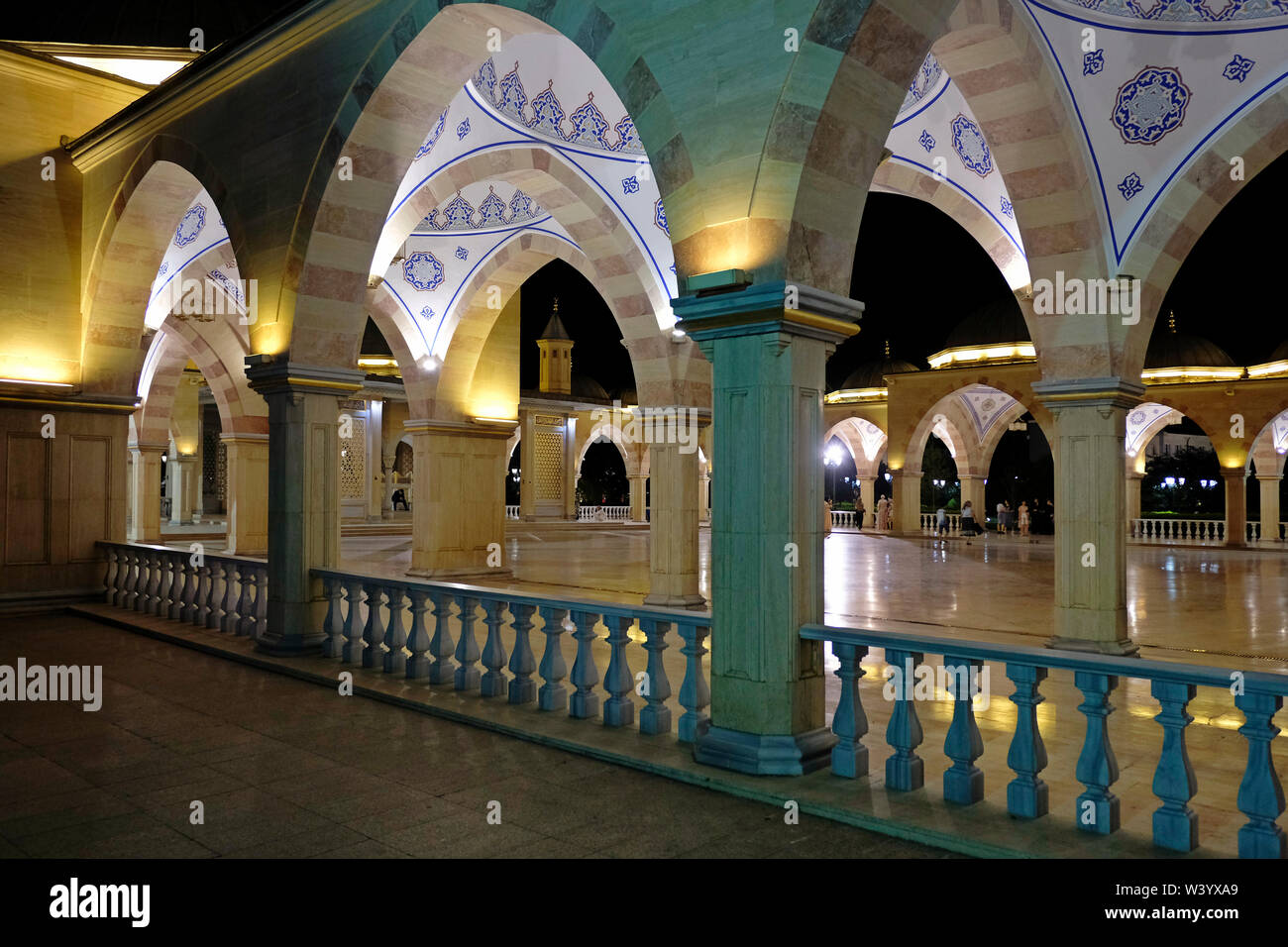 The courtyard of Akhmad Kadyrov Mosque illuminated at night in Grozny ...