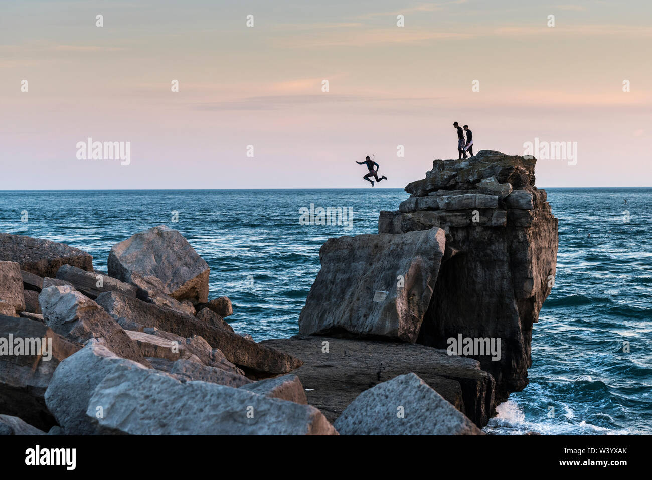Cliff jumping into ocean sunset hi-res stock photography and images - Alamy