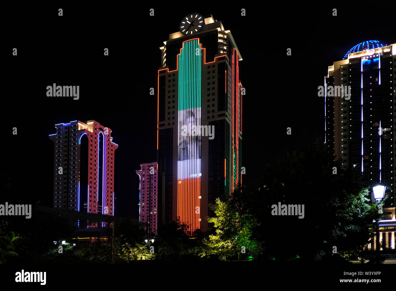 A led screen on the side of a high-rise building displays the portrait ...