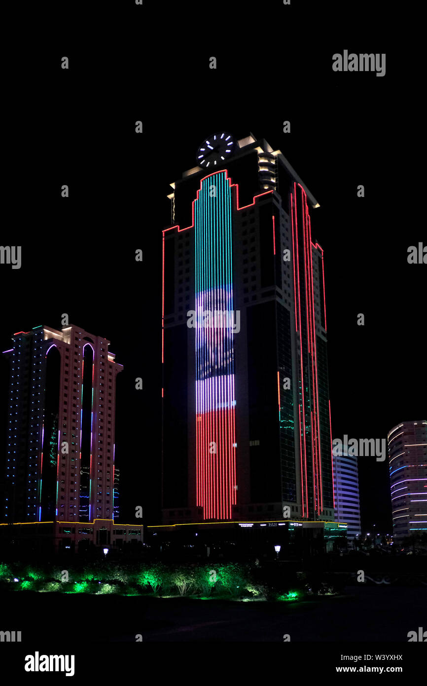 A led screen on the side of a high-rise building displays the portrait ...