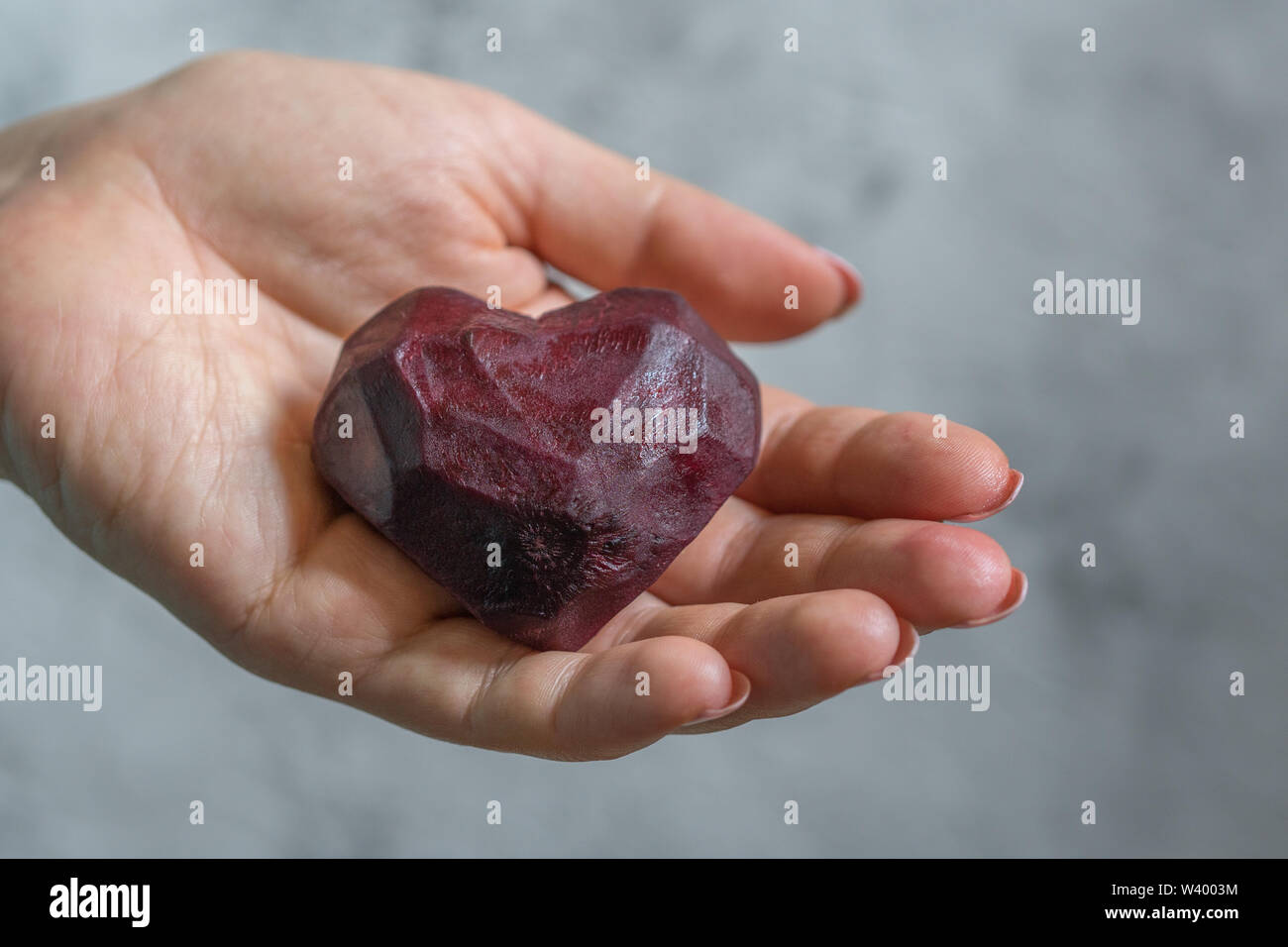 Beet heart in a hand Stock Photo - Alamy