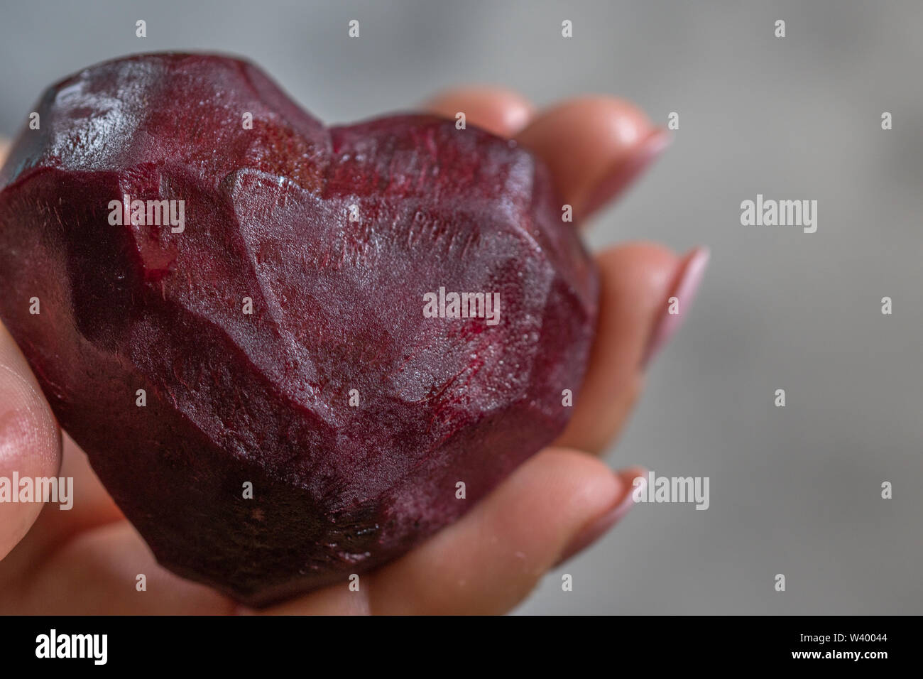 Beet heart in a hand Stock Photo - Alamy