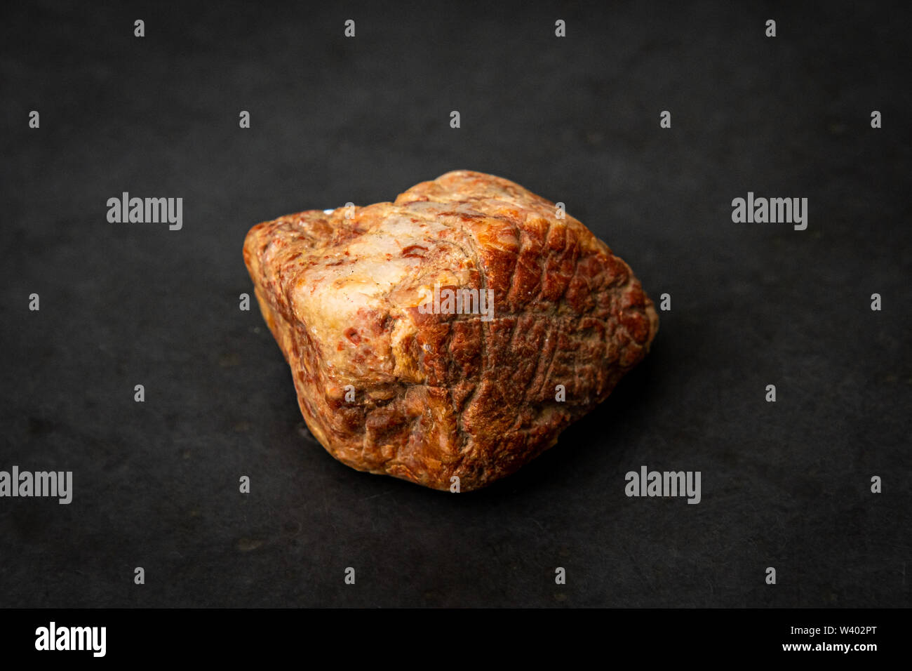Partly metamorphic rock containing red, yellow and white components ...
