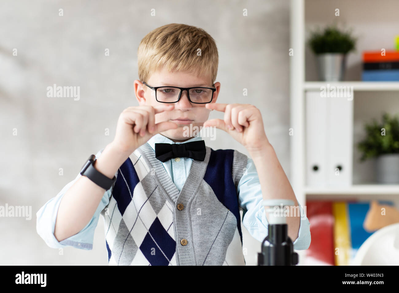 Young boy preparing samples for examination under microscope Stock ...