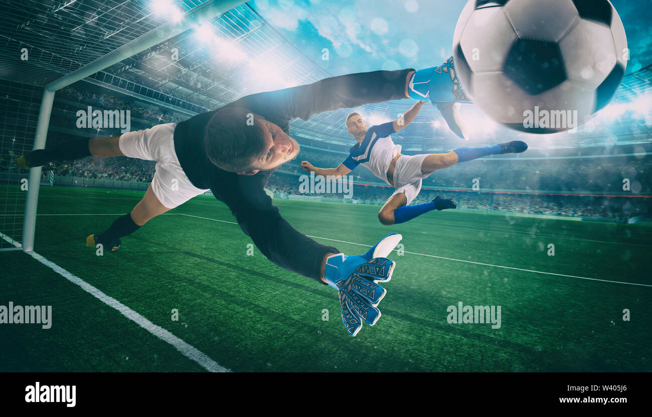 Goalkeeper catches the ball in the stadium during a football game Stock ...