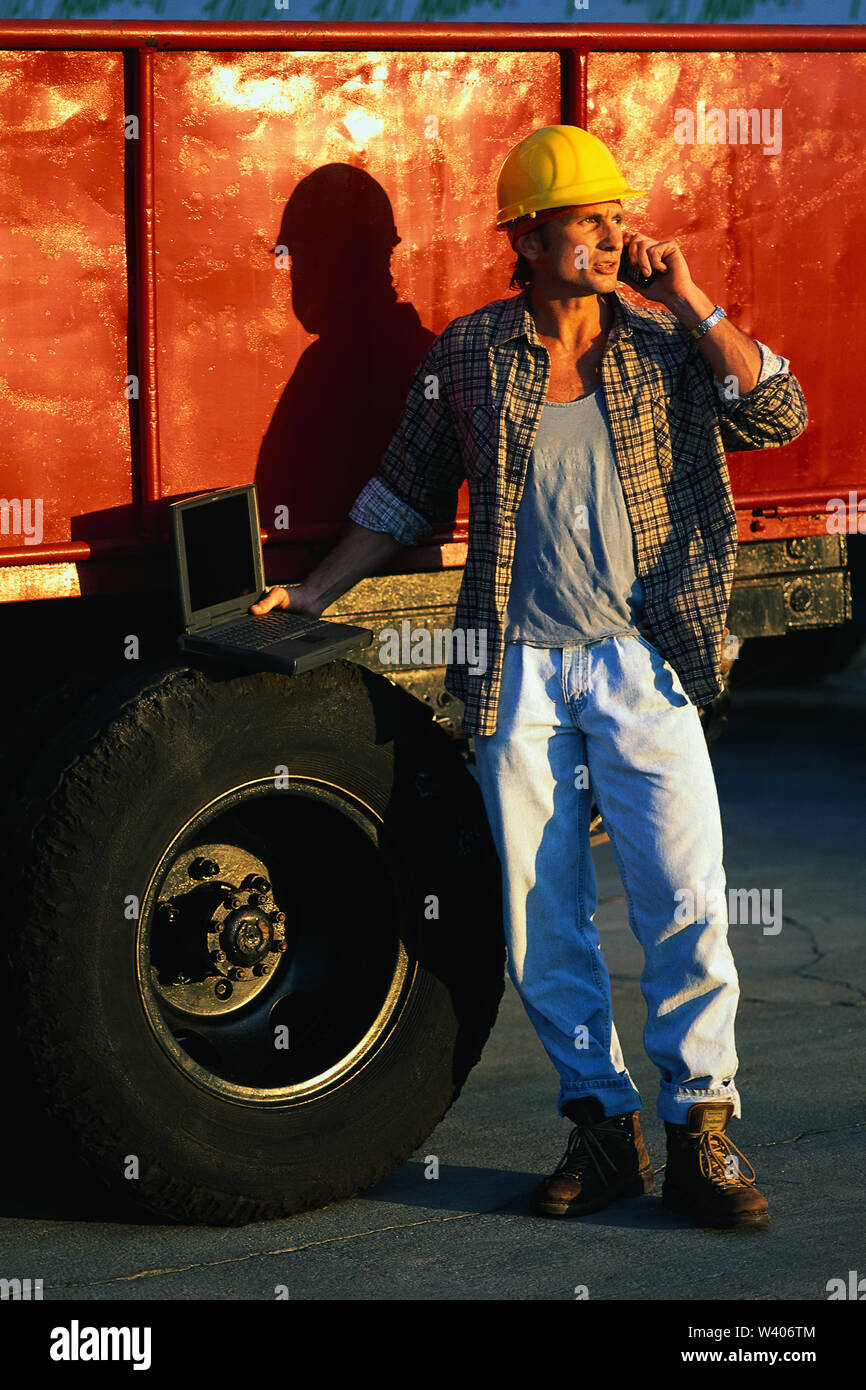 Construction worker wearing a yellow heart Stock Photo - Alamy