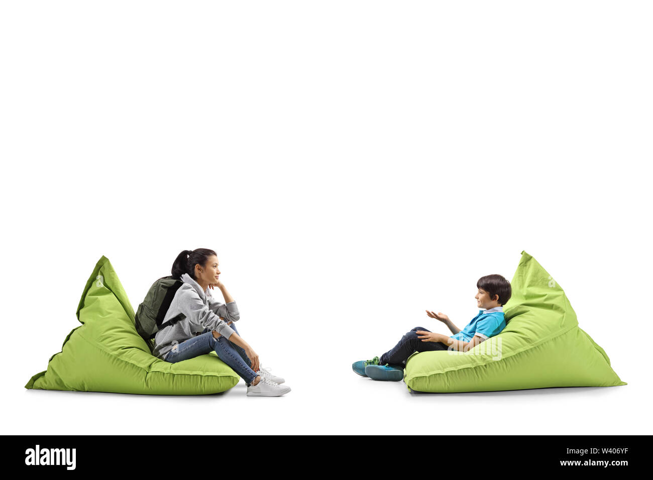 Full length profile shot of a female student and a little boy sitting ...