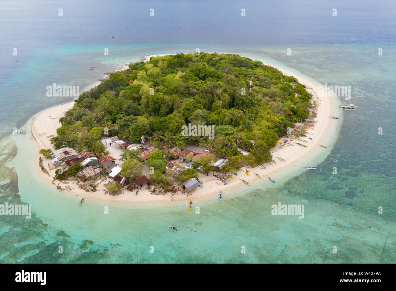 Round tropical island with white sandy beach, top view. Mantigue Island ...