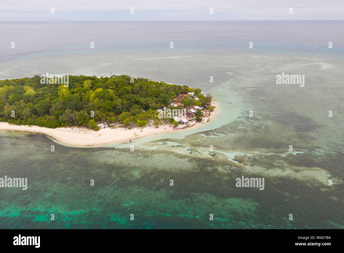 Round tropical island with white sandy beach, top view. Mantigue Island ...