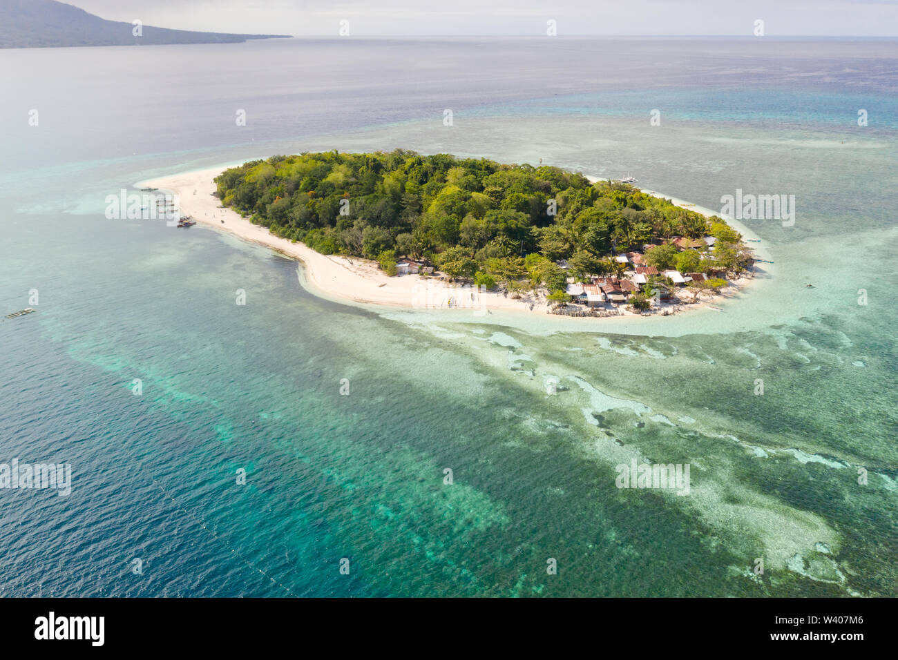 Round tropical island with white sandy beach, top view. Mantigue Island ...
