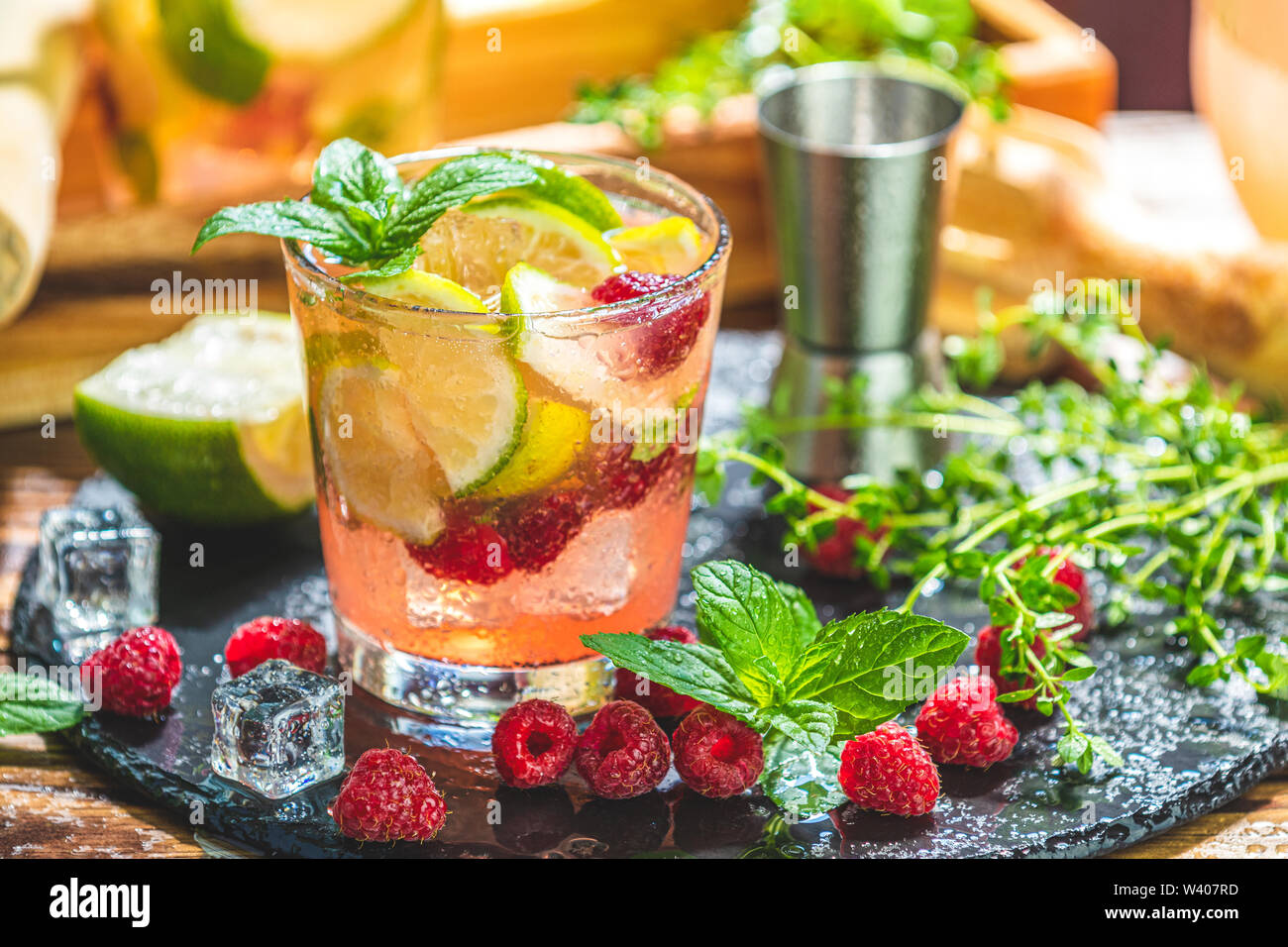 Refreshing mint cocktail mojito with rum, lime and raspberry, cold ...