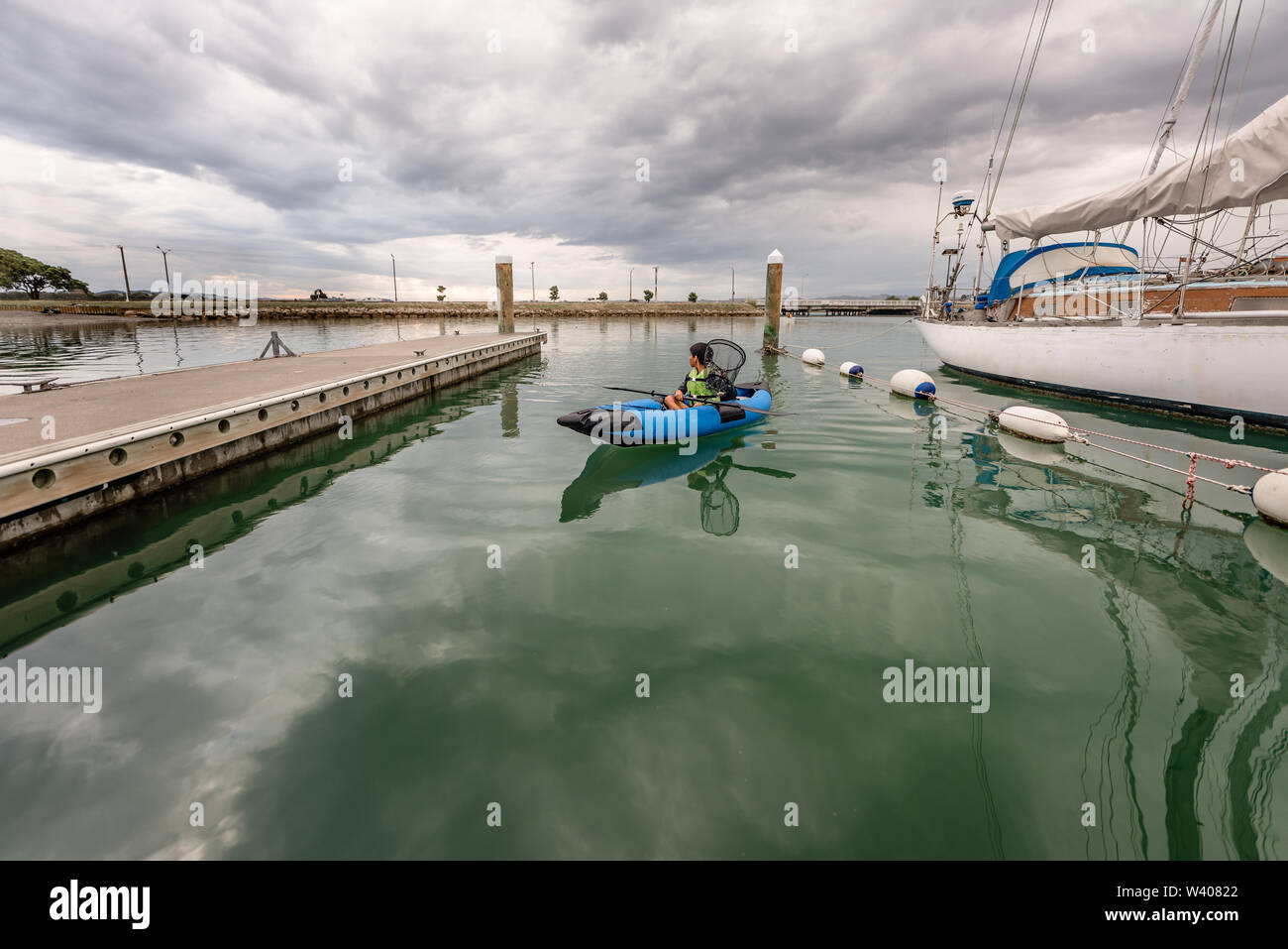 Tween boy kayaking in beautiful green water Stock Photo - Alamy