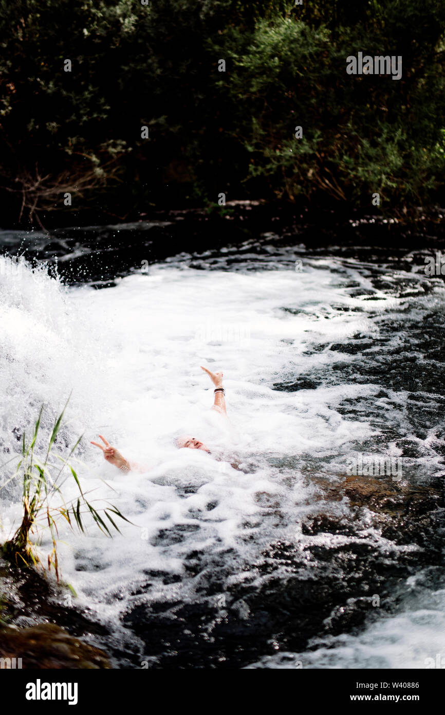 Woman bathing in waterfall hi-res stock photography and images - Alamy