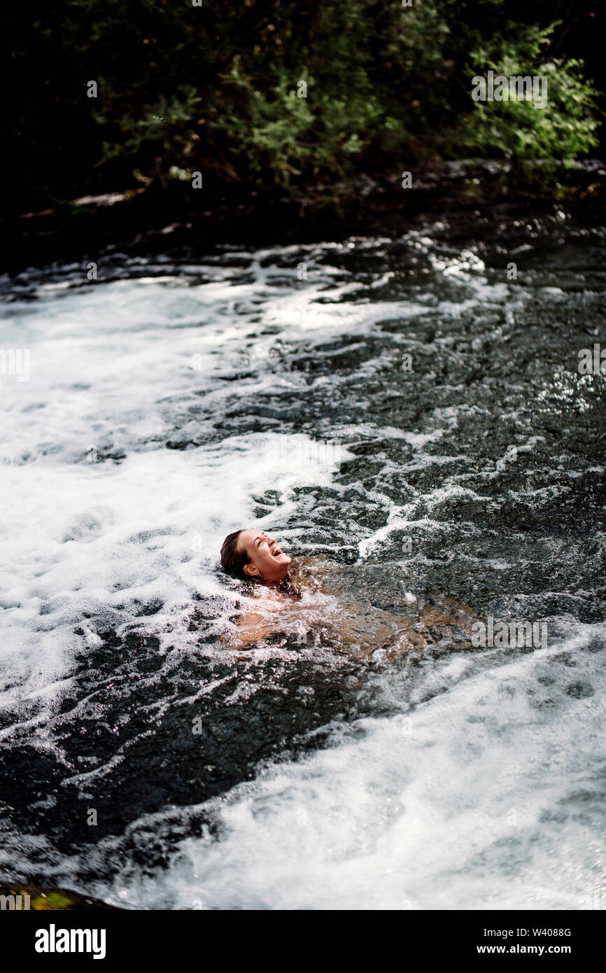 Blond woman bathing in beautiful river waterfall Stock Photo - Alamy
