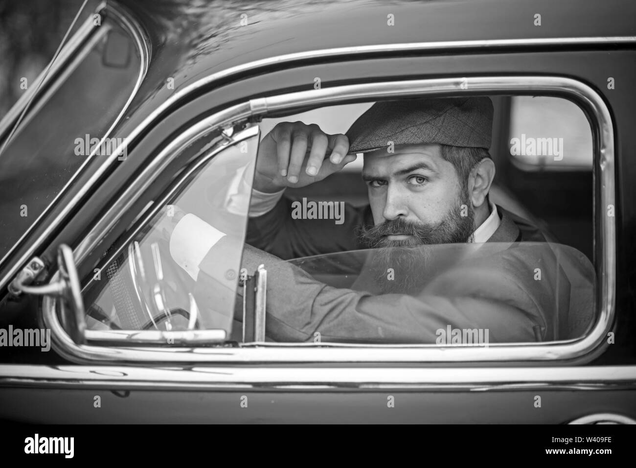 Cool guy in cap driving a retro car Stock Photo - Alamy
