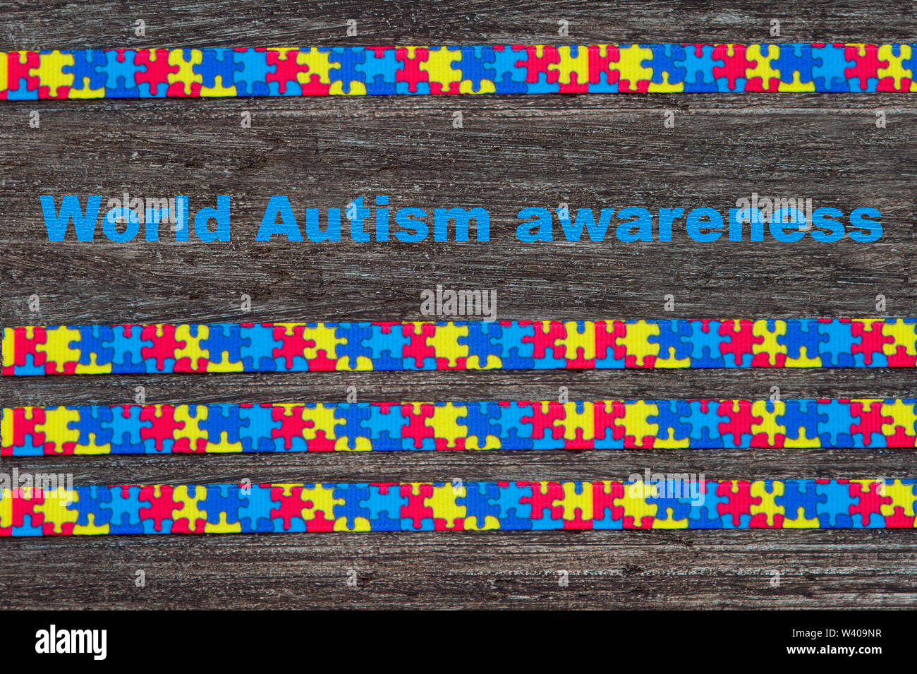 World Autism awareness day with Puzzle ribbon on wooden background ...