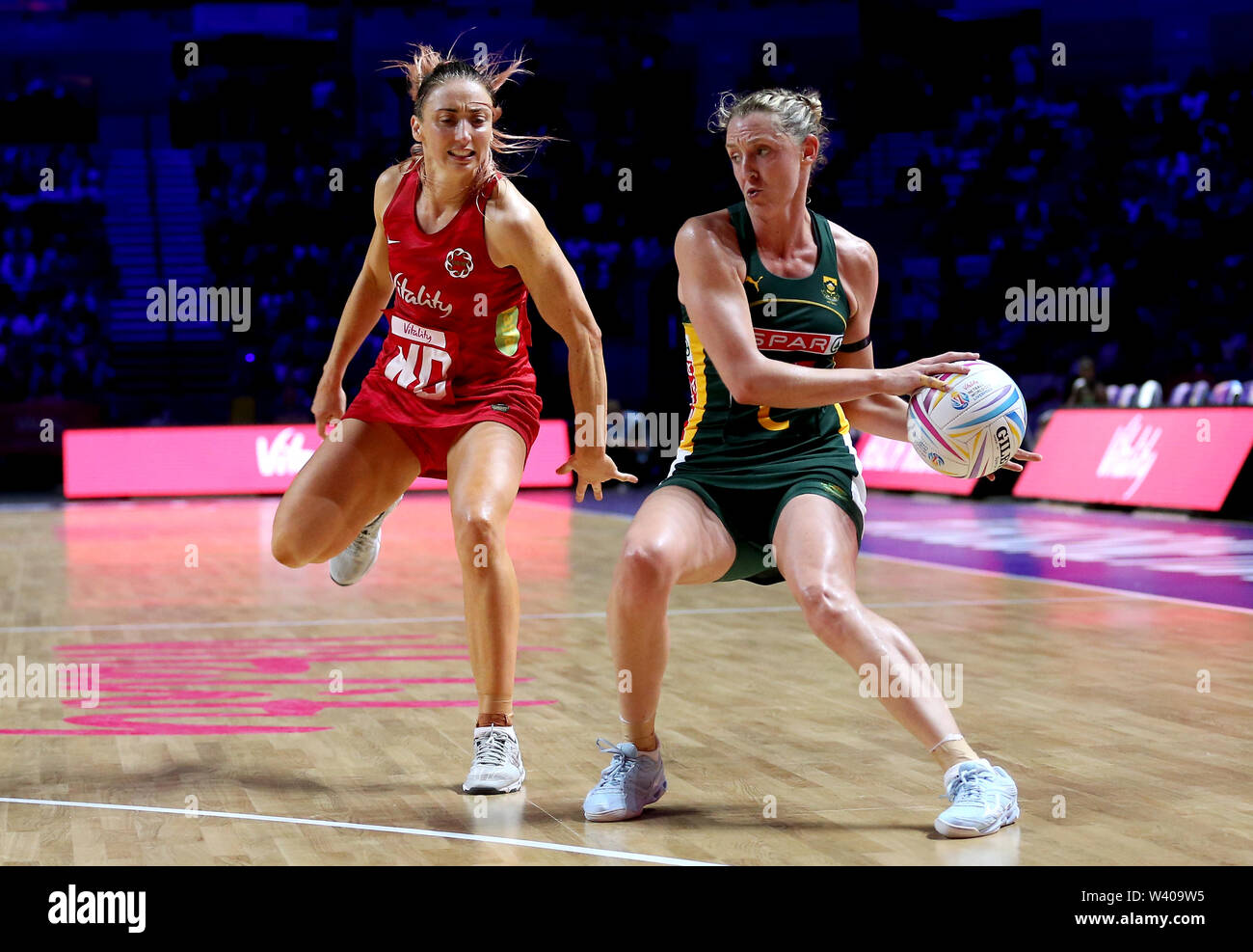 England's Jade Clarke (left) and South Africa's Erin Burger in action ...