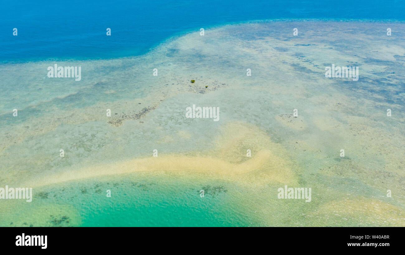 Atoll with turquoise lagoons and shoals, top view. Coral reef and clear ...