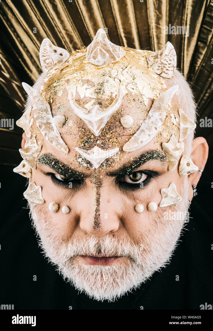 Closeup demon face with evil eyes on black background. Monster with ...