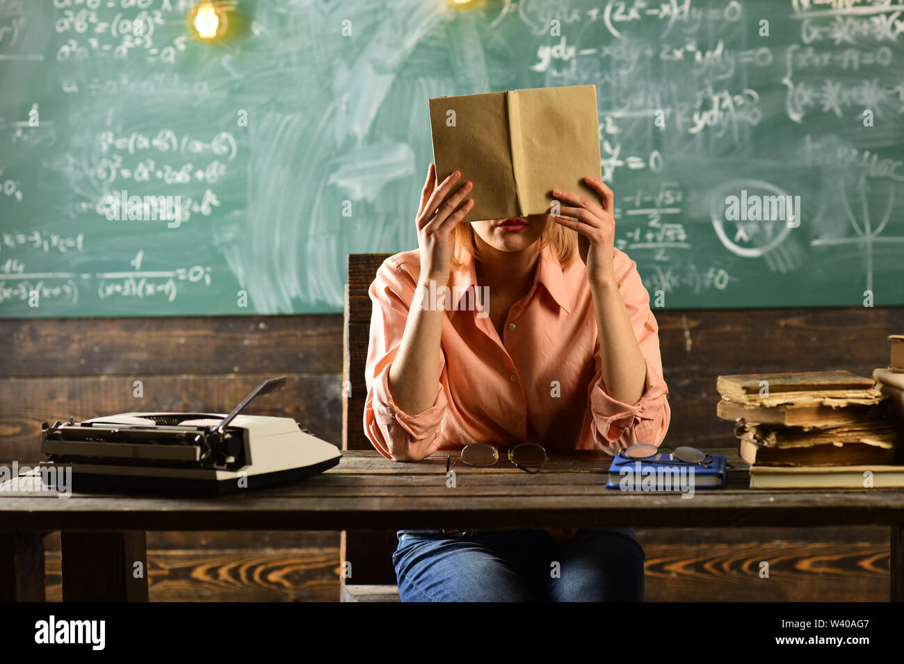 Overwork of school teacher reading book in classroom. Overwork and ...