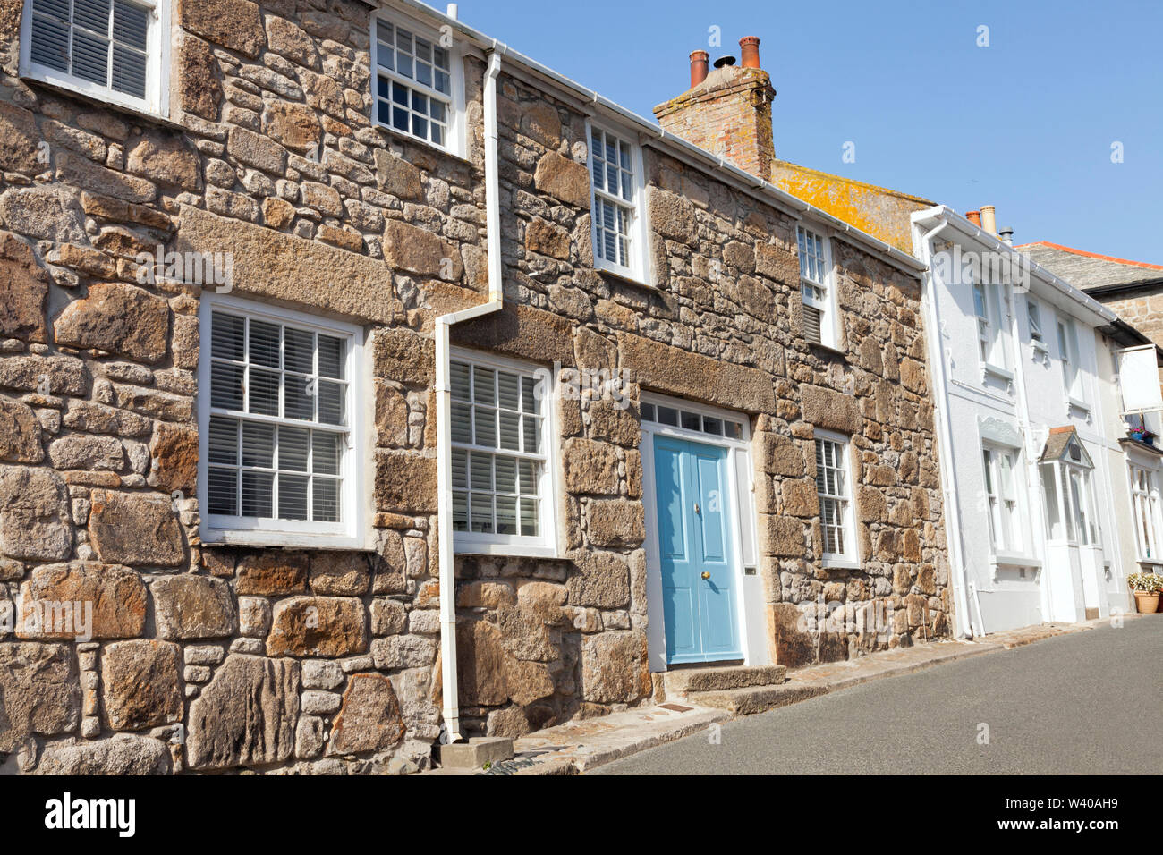 Narrow street with traditional stone houses in a coastal town of St ...