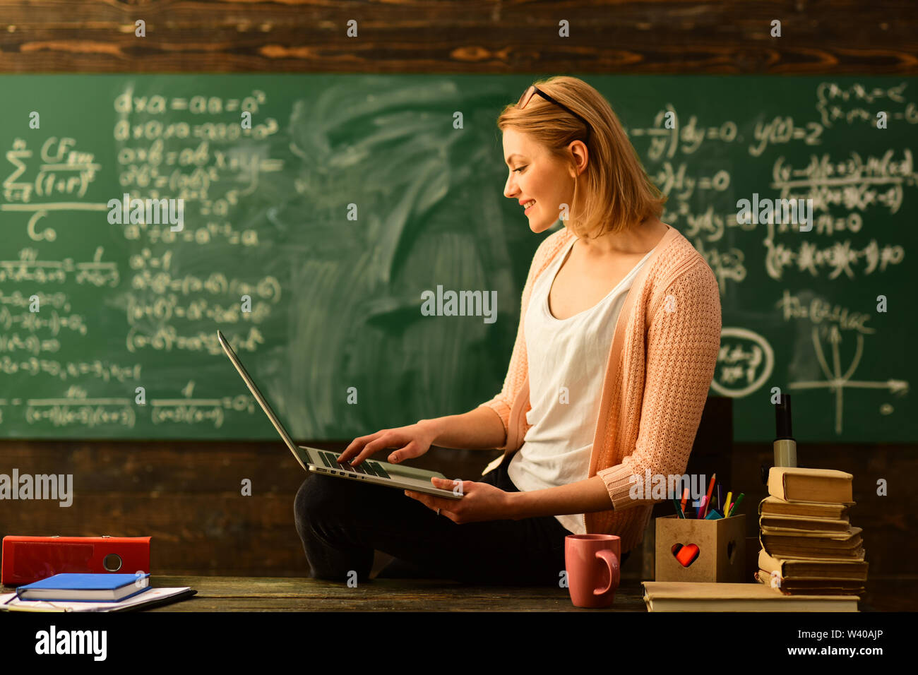 Desire to help should be in the tutor by nature, Pretty teacher helping ...