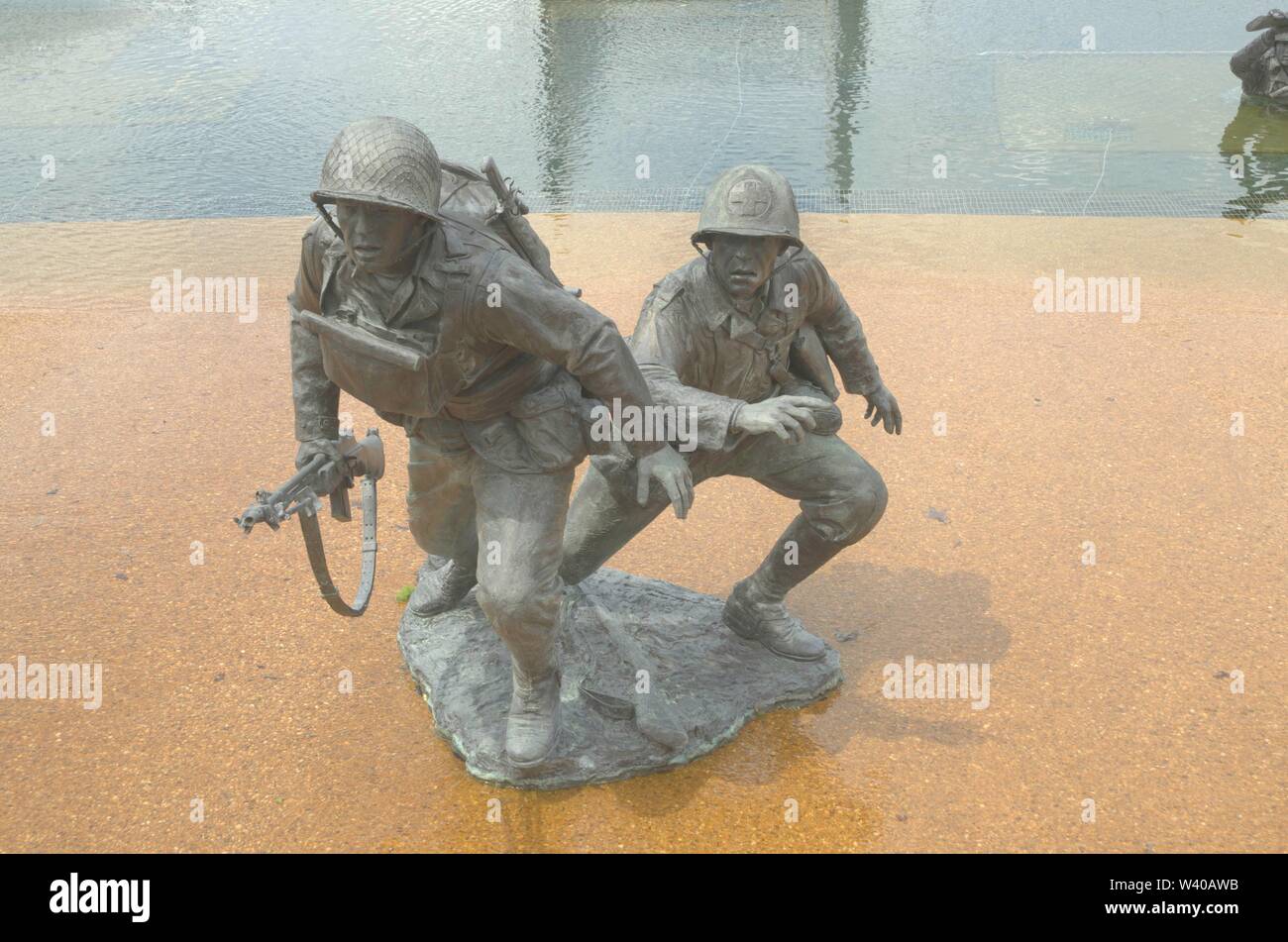 Statues of soldiers invading during D-Day are depicted at the Memorial ...