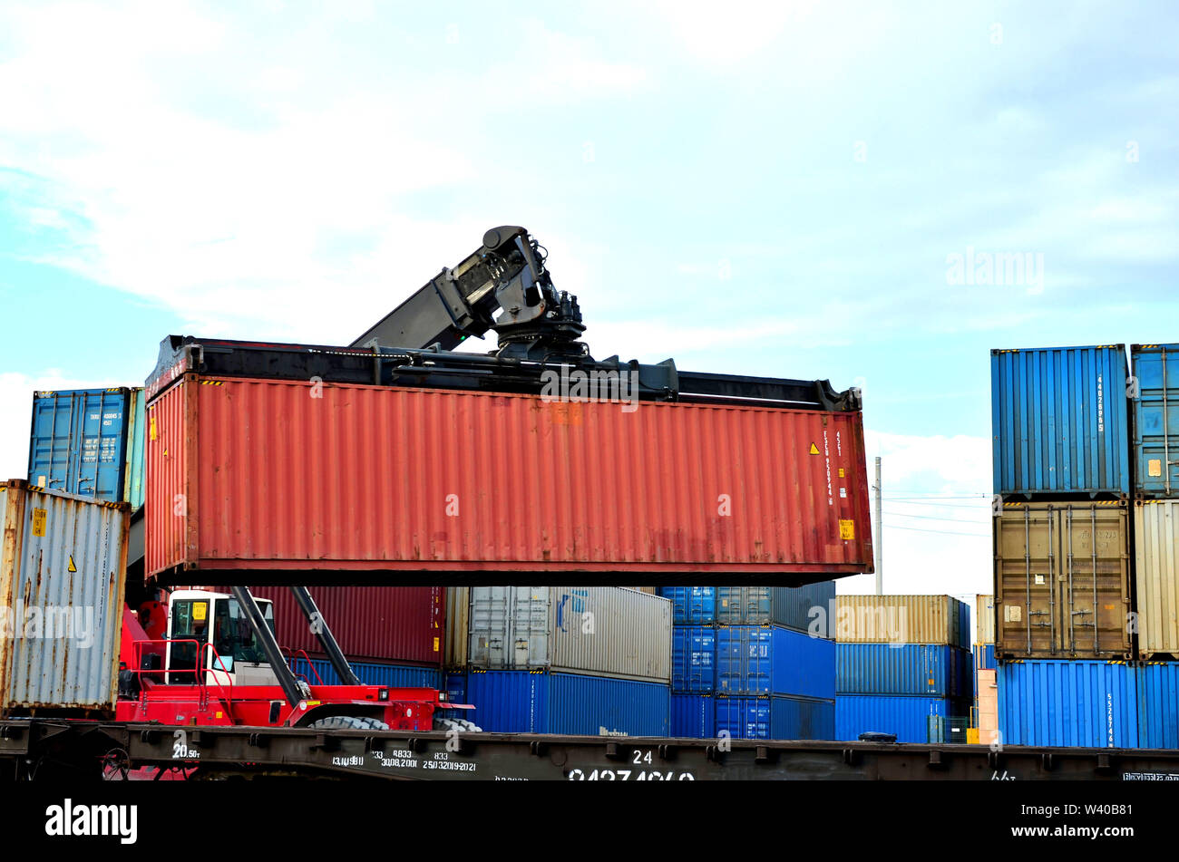 Shipping container loading by richtracker on the freight rail car at ...