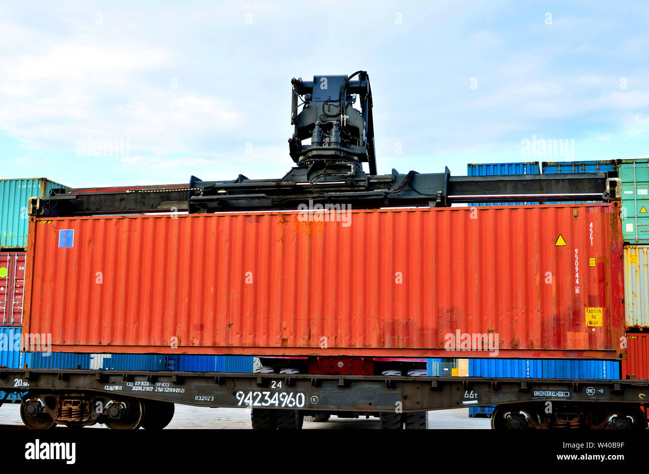 Shipping container loading by richtracker on the freight rail car at ...
