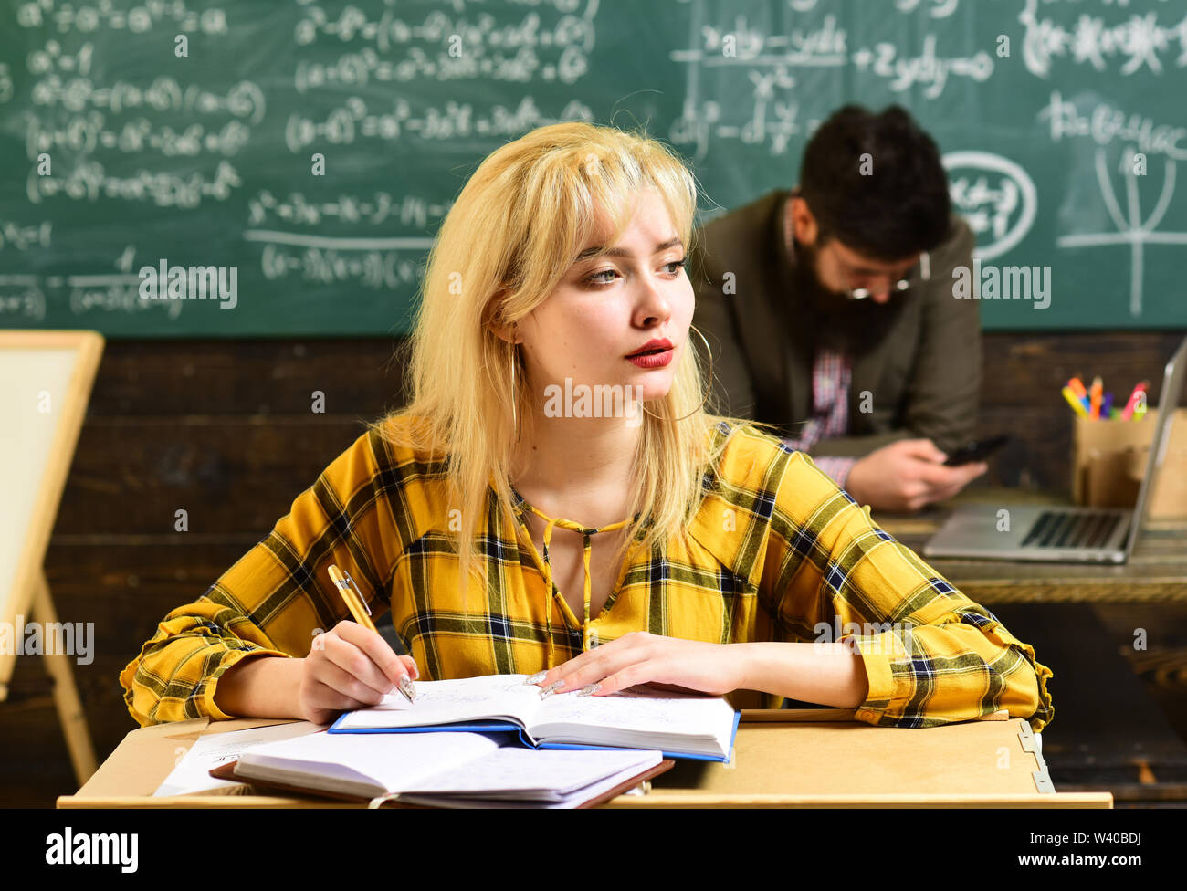 Students studying and testing lesson from teacher in classroom at ...