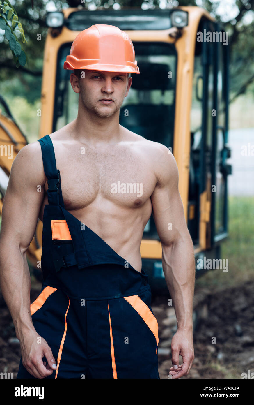 Operator concept. Excavator operator on construction site. Muscular ...
