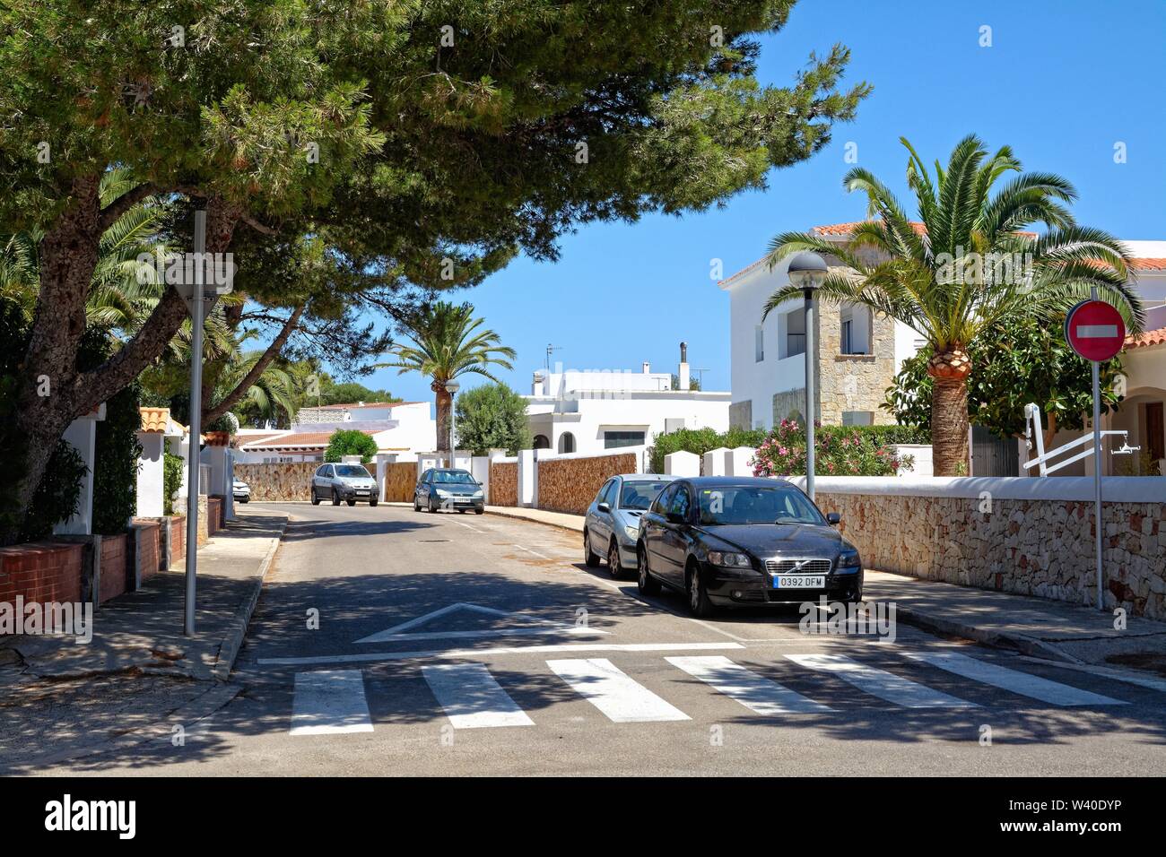 A residential street in summertime Cala Blanca Minorca Balearic Islands ...