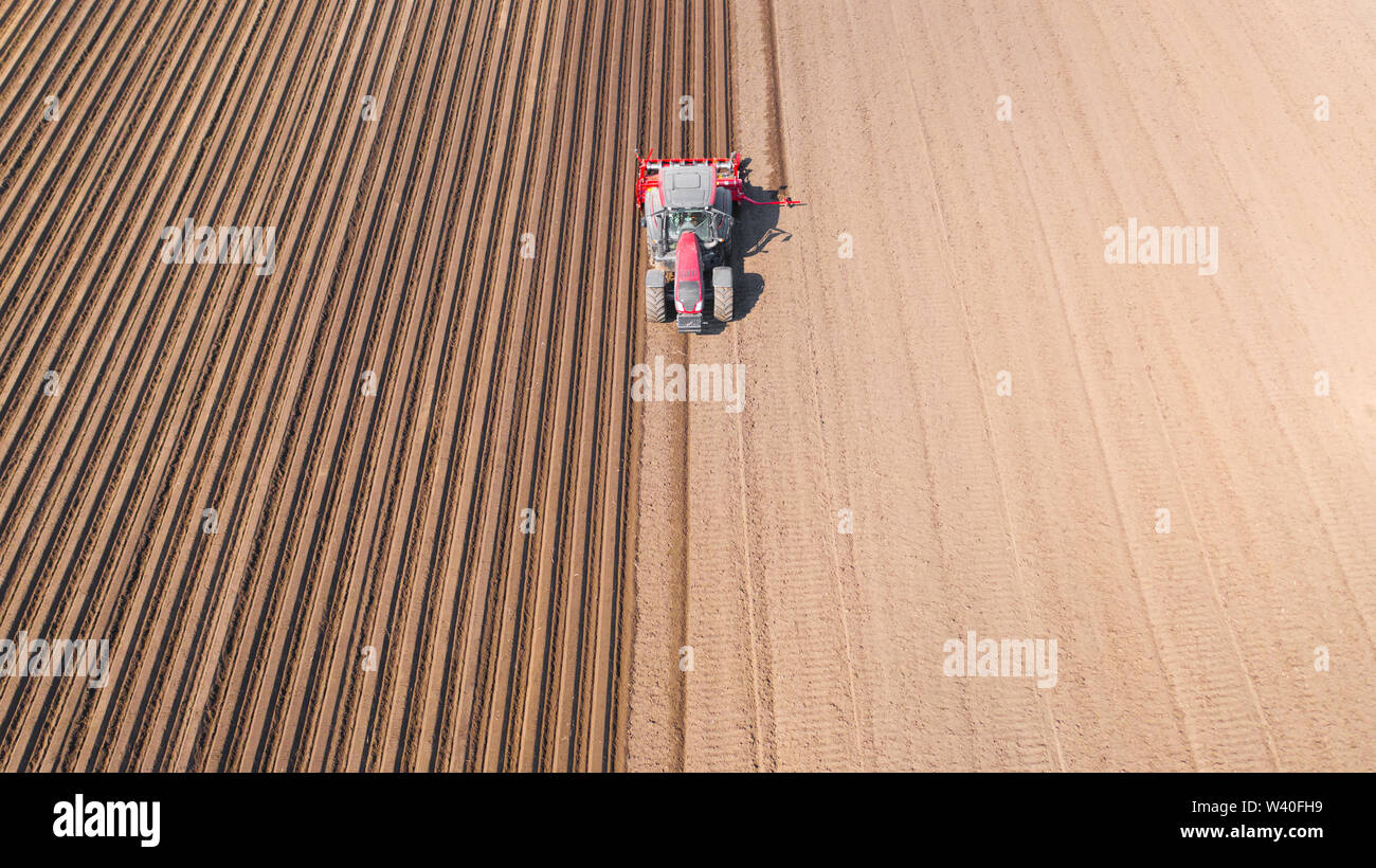 Tractor on a plowed field, top view. Agricultural field for planting ...