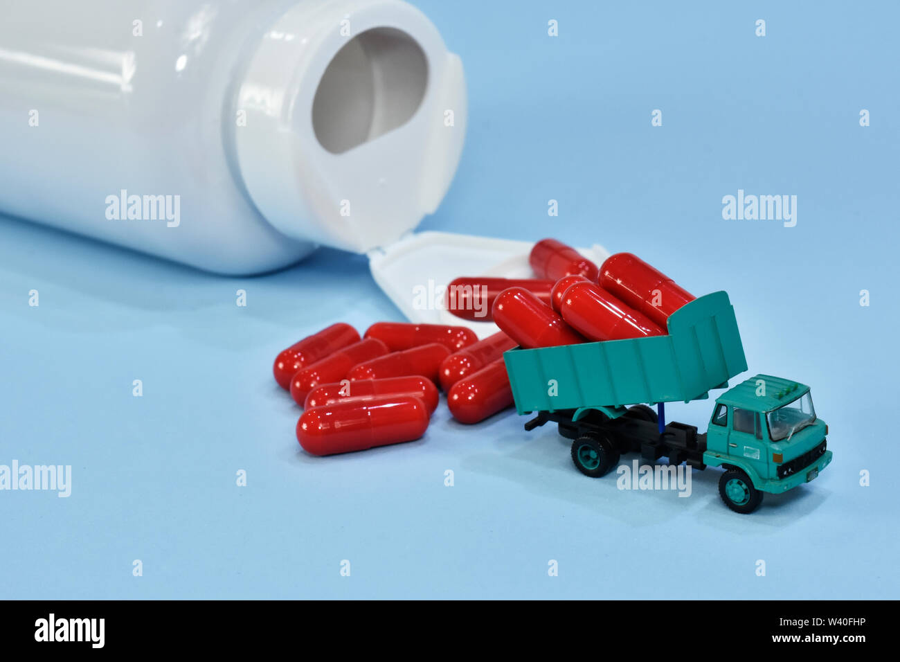Capsules from bottle. Truck carrying some capsules. transportation of ...