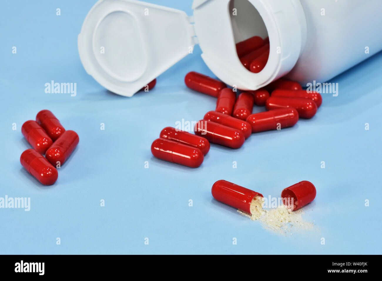 Open capsule with powder coming out. Dosing with opened suddenly tablet ...