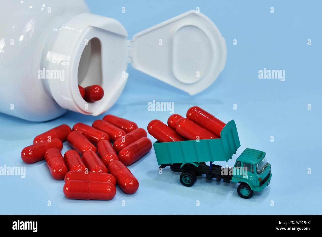 Capsules from bottle. Truck carrying some capsules. transportation of ...