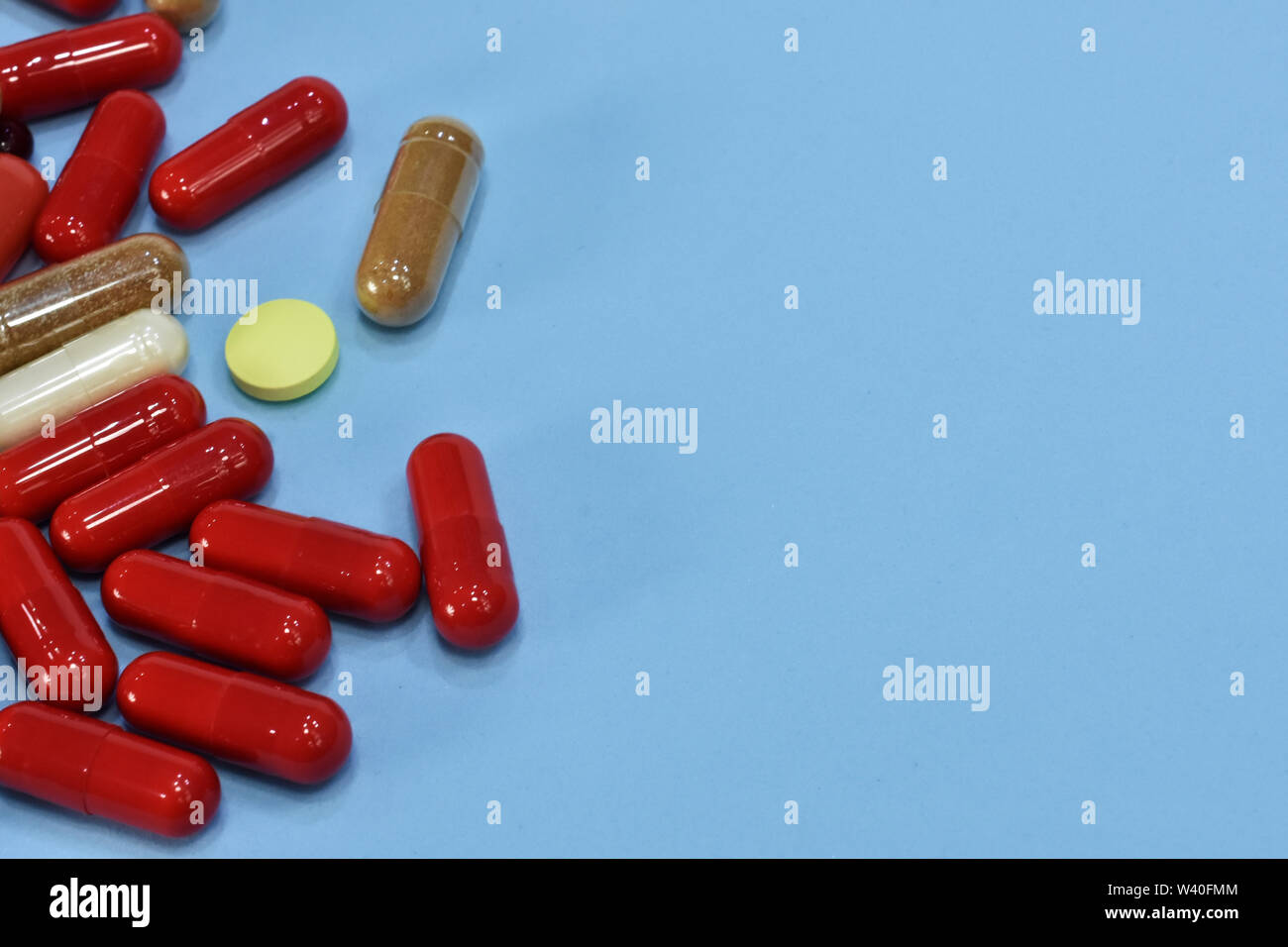 Top view of colorful tablets and capsules over blue background Stock ...