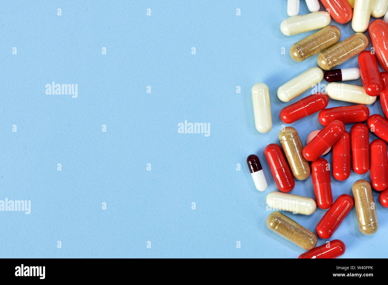 Top view of colorful tablets and capsules over blue background Stock ...