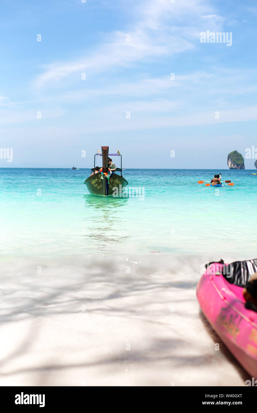 view from a clean sandy beach to a boat in the blue lagoon Stock Photo ...