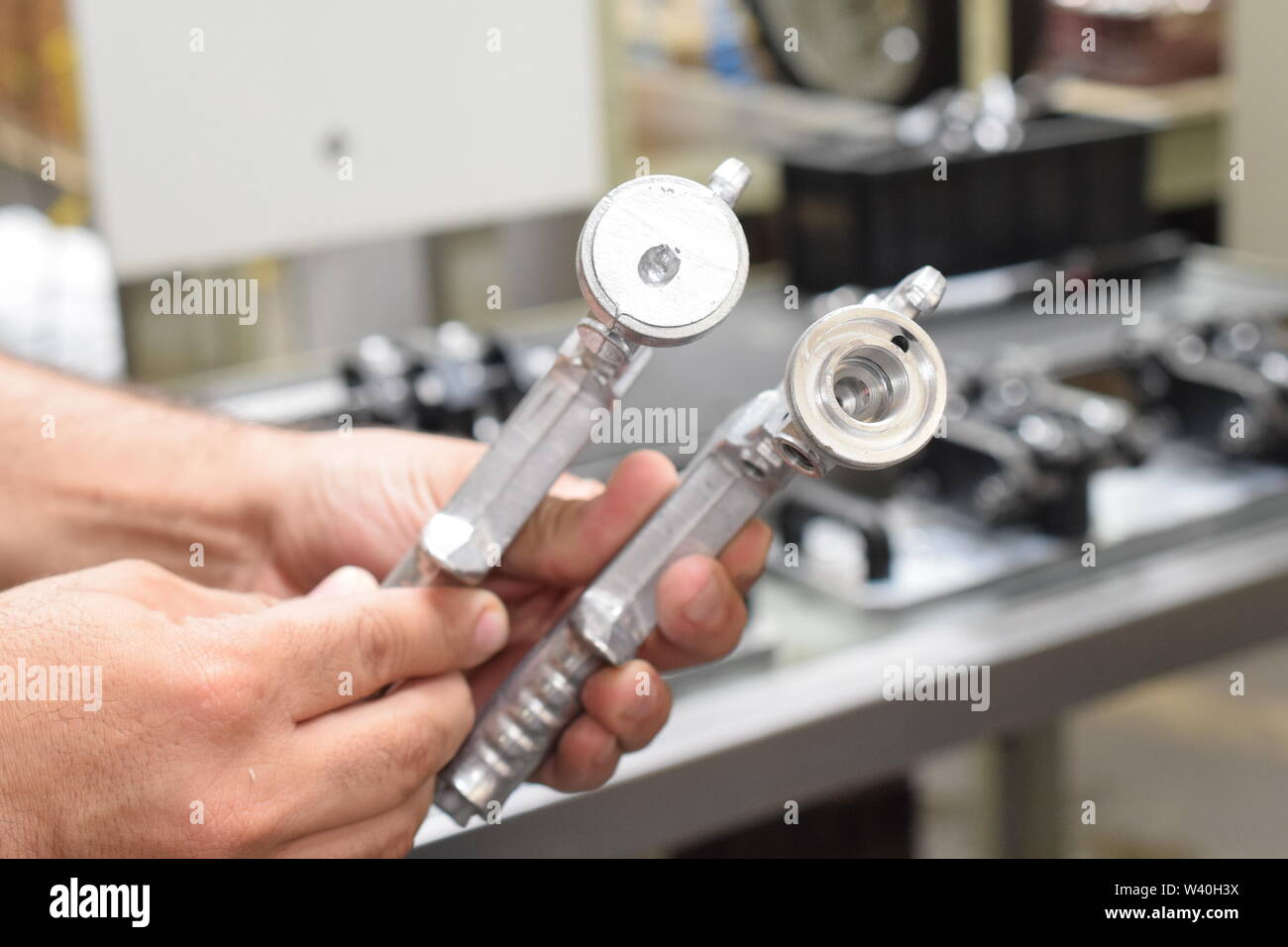 Before and after machining a spray gun in a factory Stock Photo - Alamy