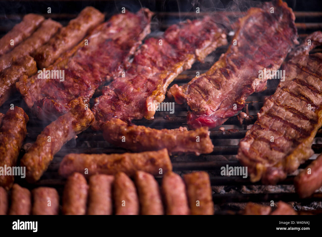 Assorted delicious grilled meat over the coals on barbecue Stock Photo ...