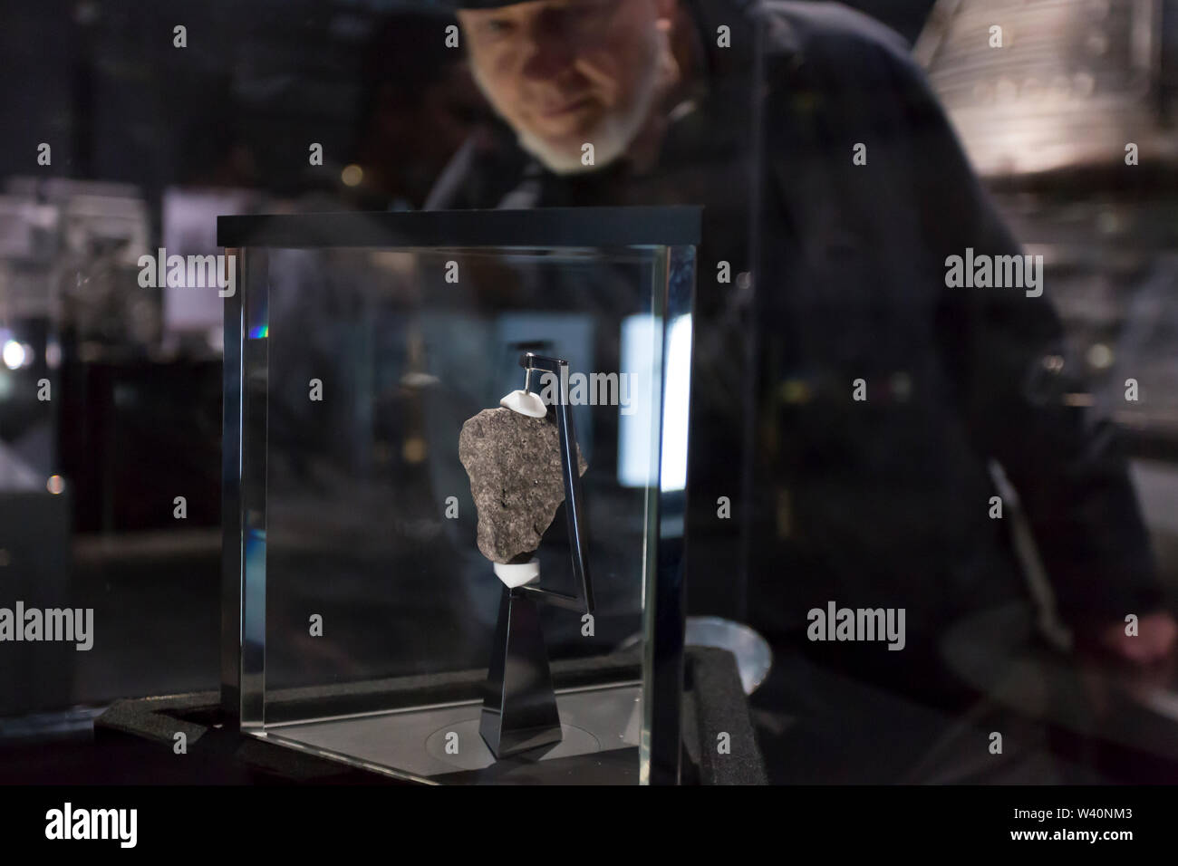 A visitor examines a moon rock from the Apollo 12 mission during the ...