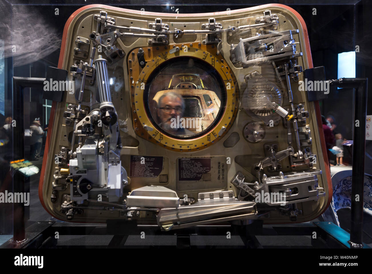 A visitor looks through the window of the unattached door of the ...